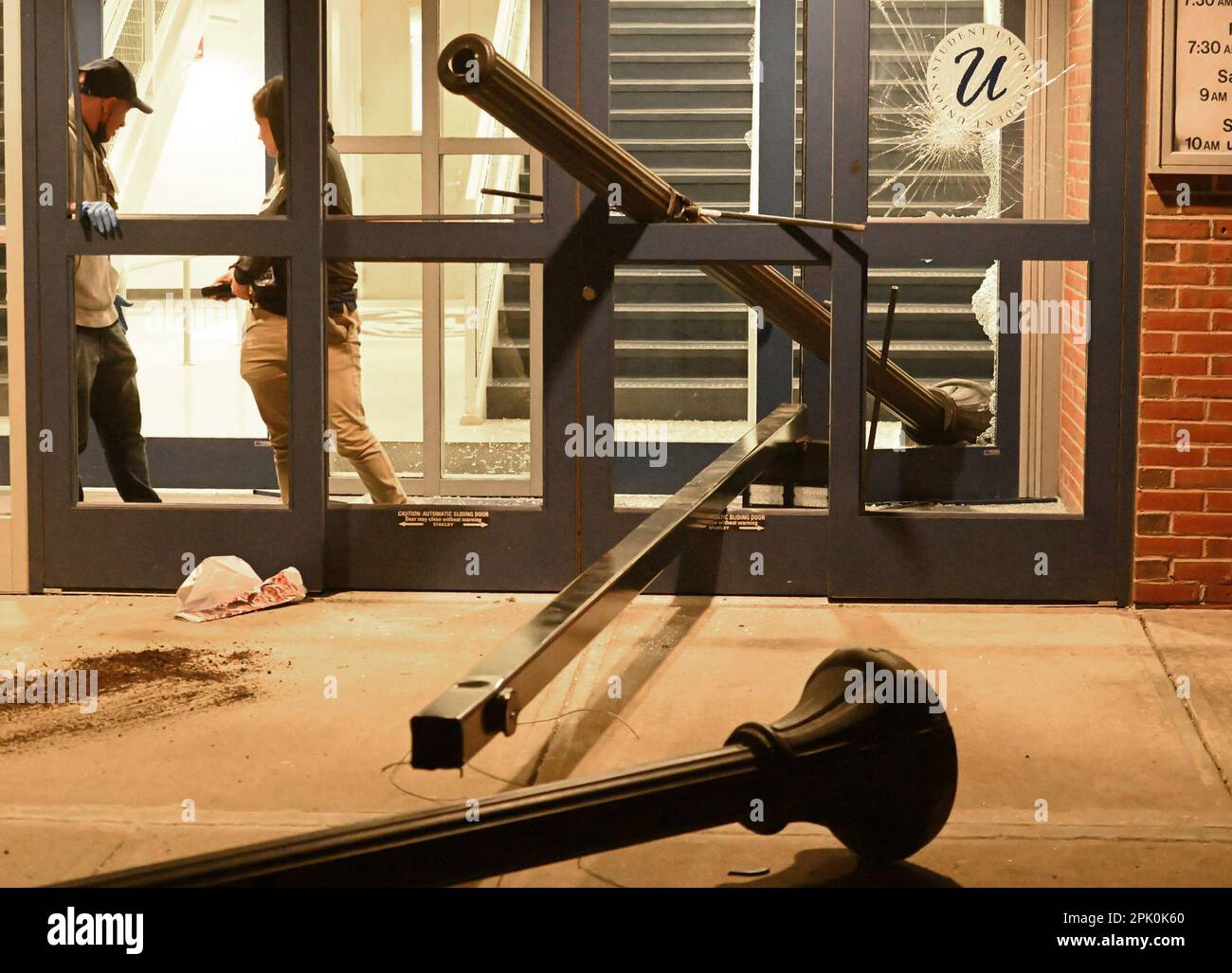 Two light poles are seen smashed through plate glass windows at the ...