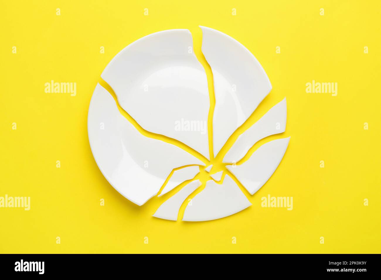 Pieces of broken ceramic plate on yellow background, flat lay Stock ...