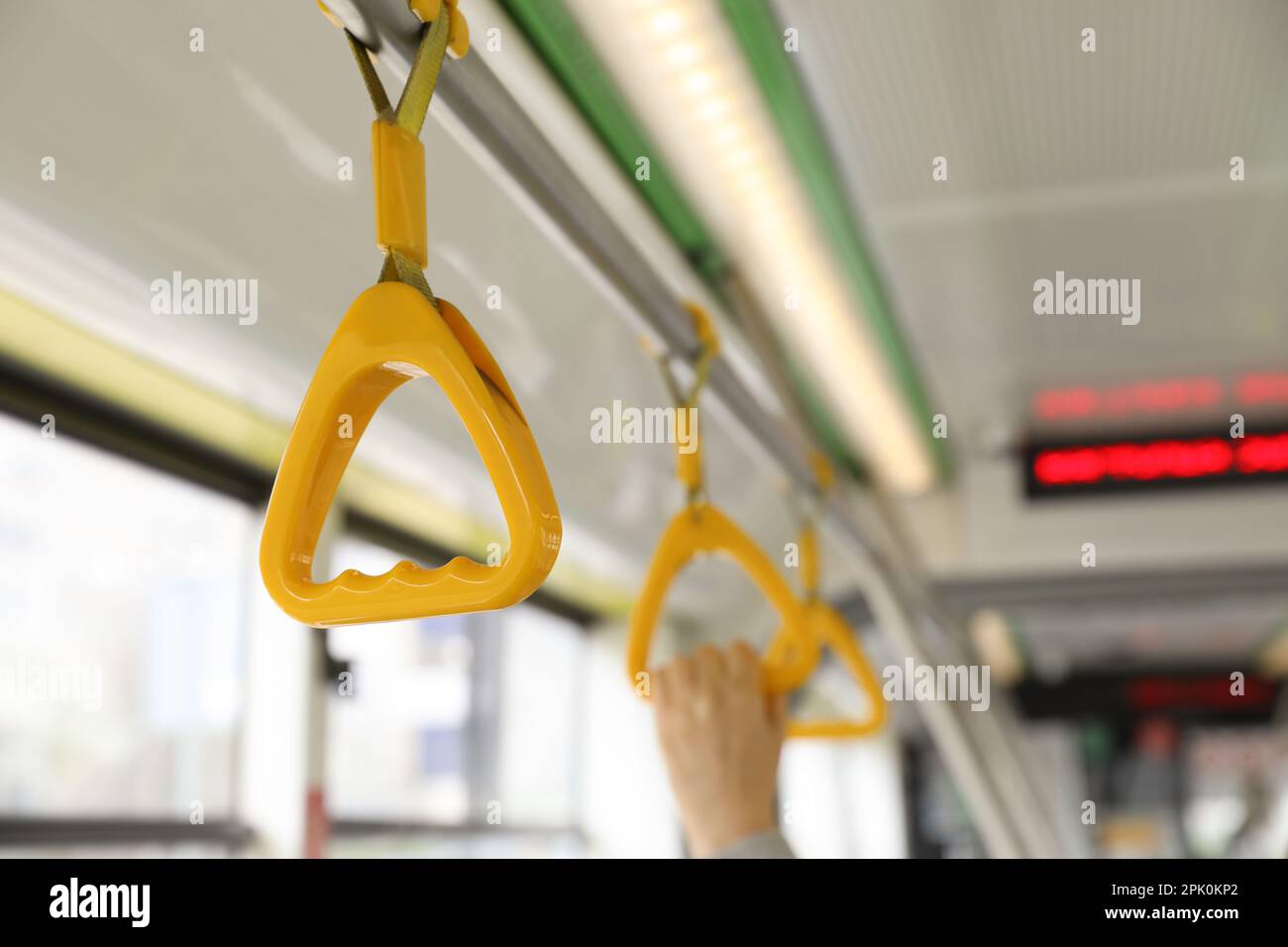 Grab pole with handgrip handles in public transport Stock Photo - Alamy
