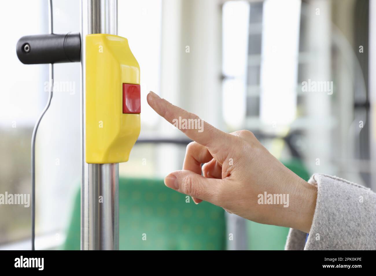 Woman pressing stop button in public transport, closeup Stock Photo - Alamy