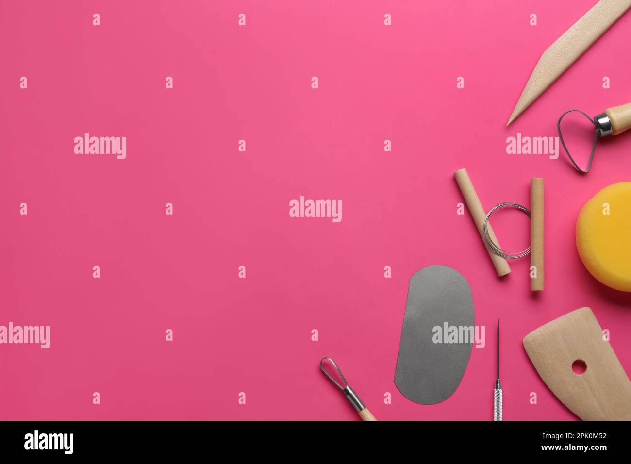 Set of clay modeling tools on pink background, flat lay. Space for text ...