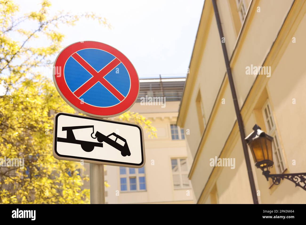 Post with No stopping road sign and complementary plate outdoors, low ...