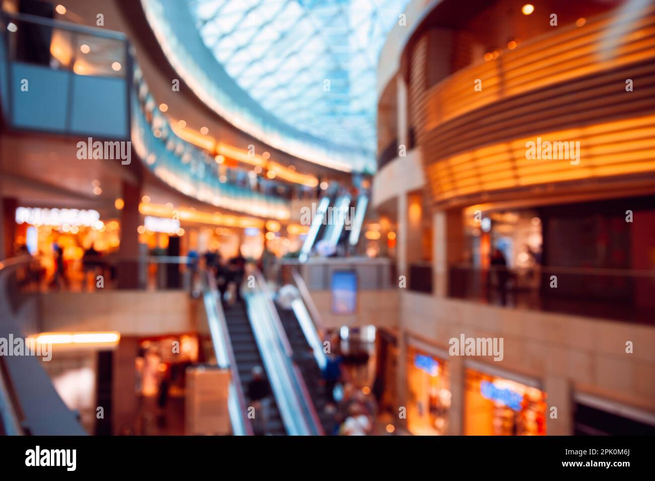 Big shopping mall with many stores, blurred view Stock Photo - Alamy