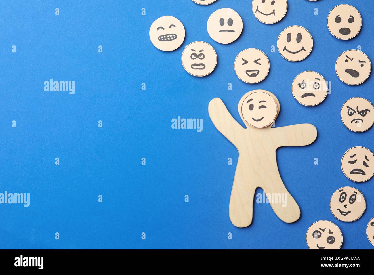 Many faces with different emotions on blue background, flat lay. Space ...
