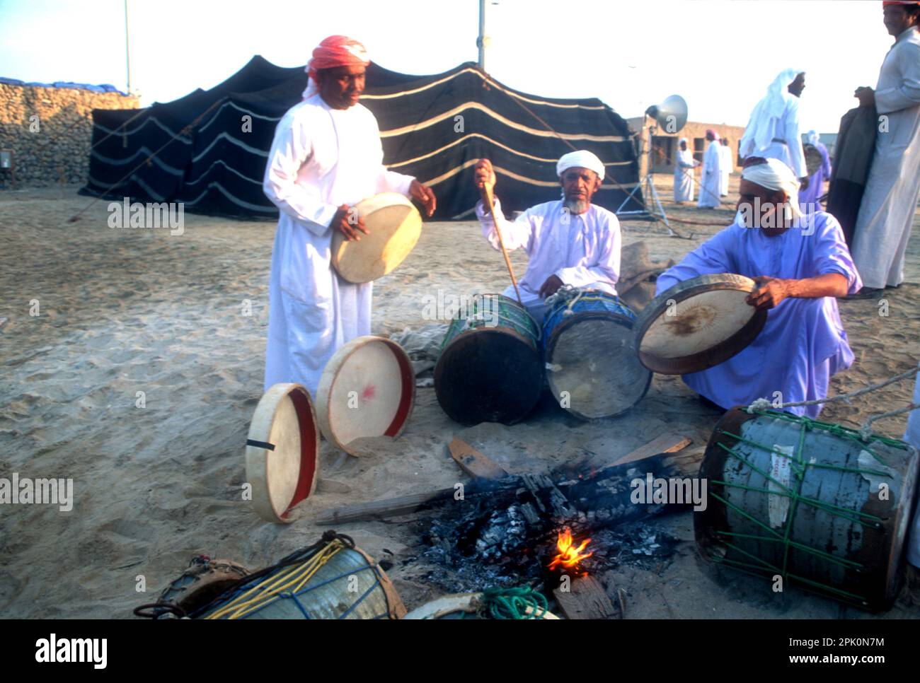 Arab musicians warm their camel skin drums before a performance in Abu ...