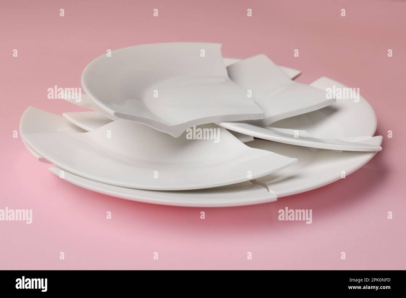 Pieces of broken ceramic plate on pink background, closeup Stock Photo ...
