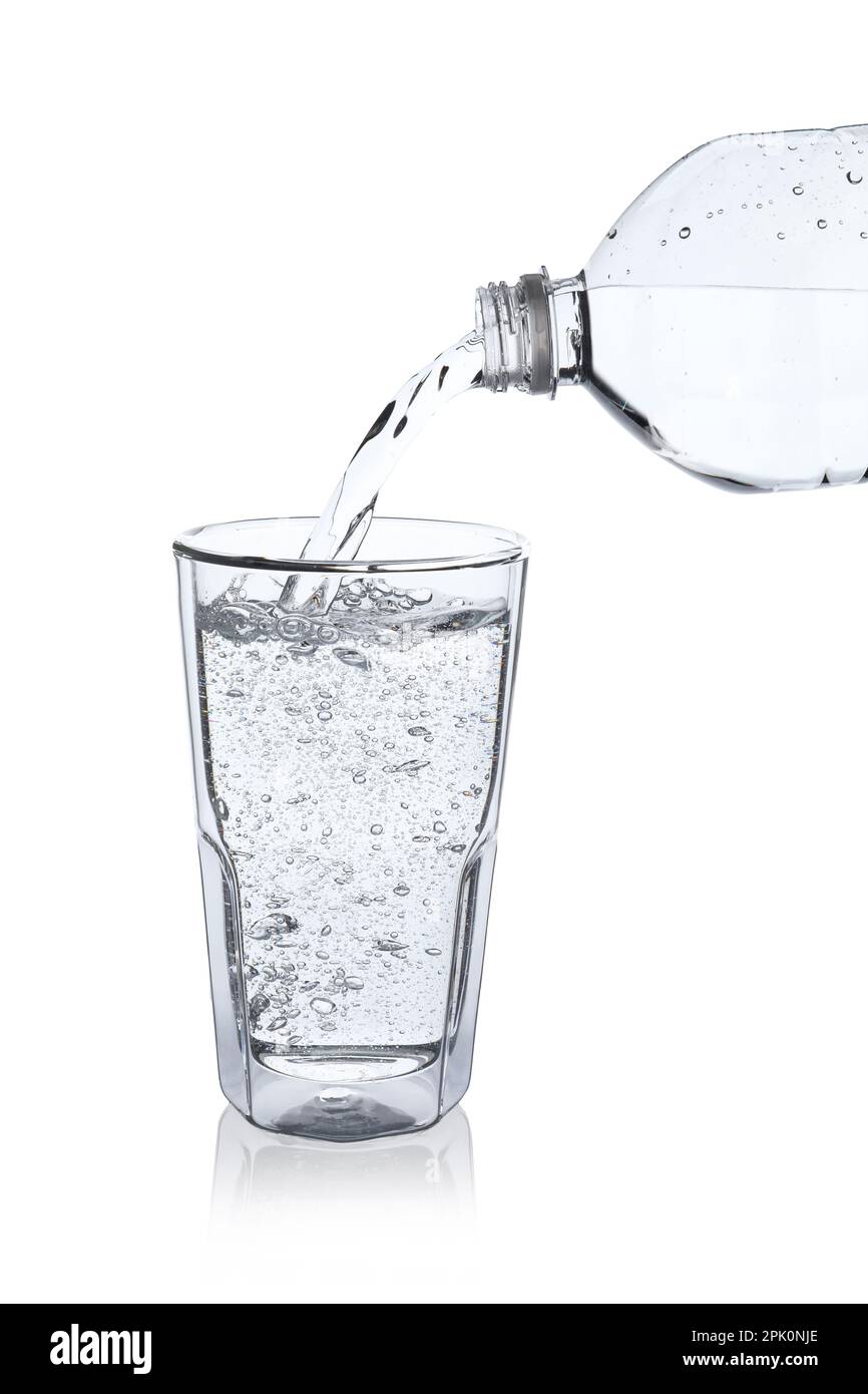 Pouring soda water from bottle into glass on white background Stock ...