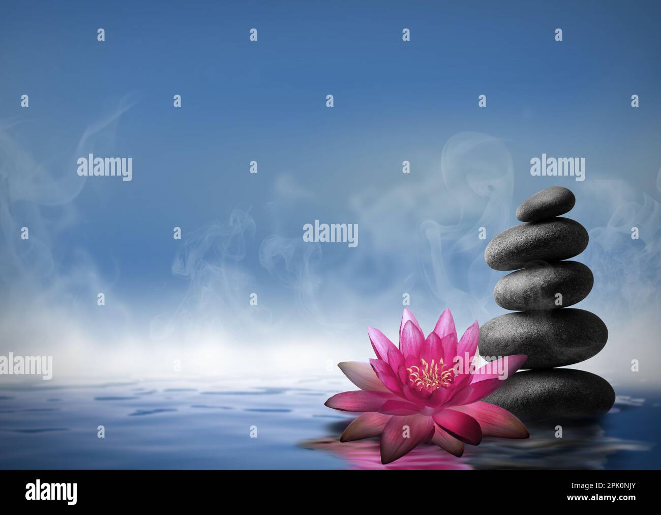 Zen, meditation, harmony. Beautiful lotus flower and stack of stones on ...