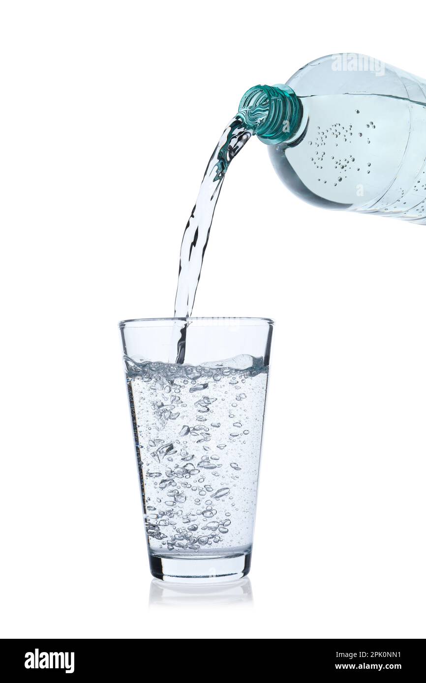 Pouring soda water from bottle into glass on white background Stock ...