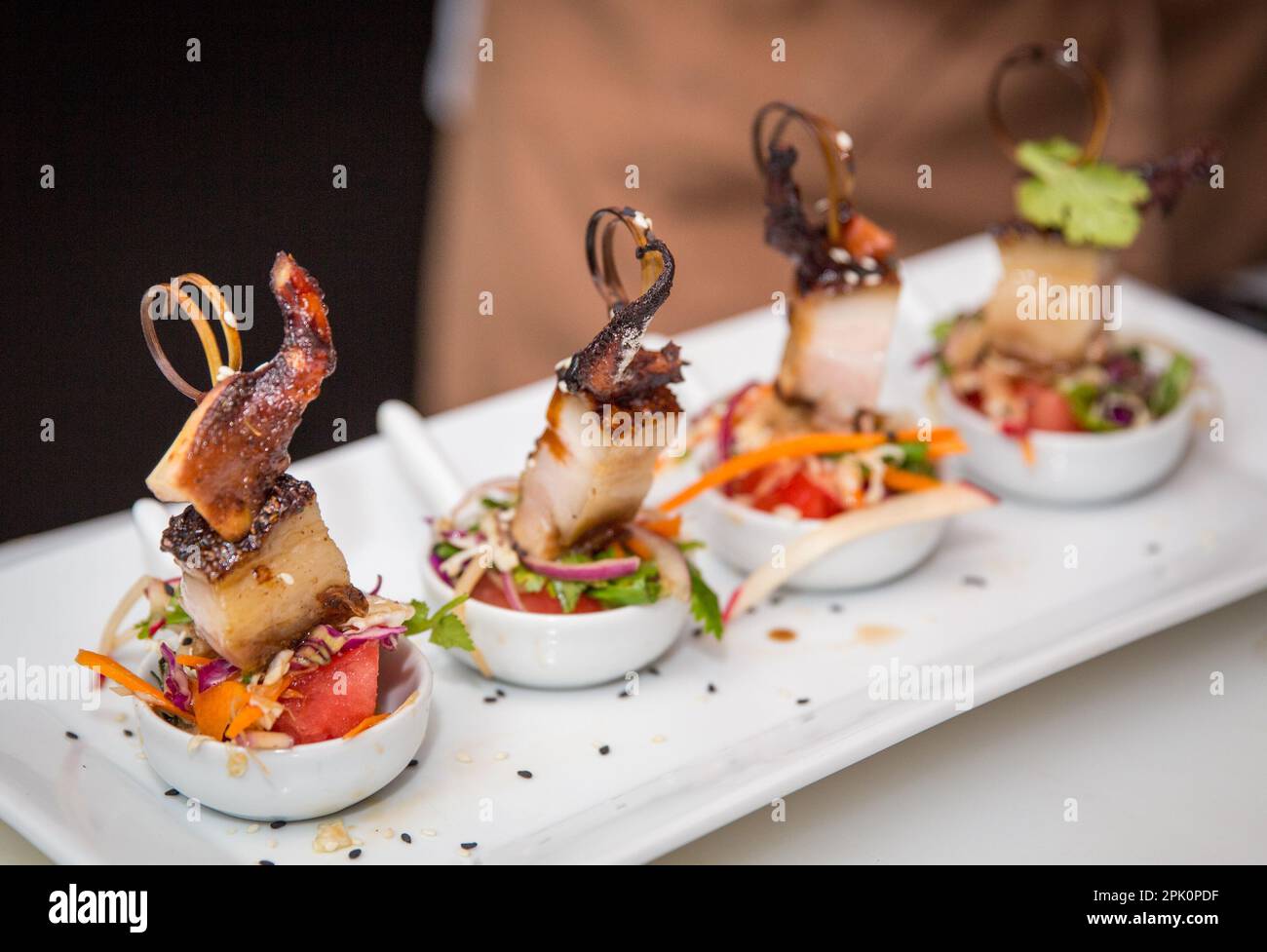 Grilled Octopus and Pork Belly on top of a small salad Stock Photo - Alamy