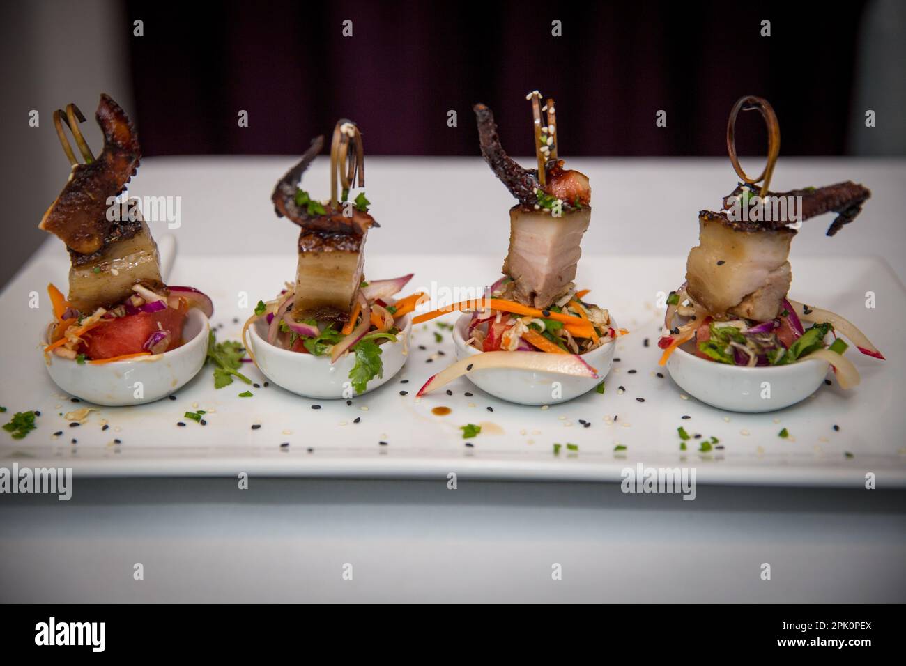 Grilled Octopus and Pork Belly as an appetizer Stock Photo - Alamy