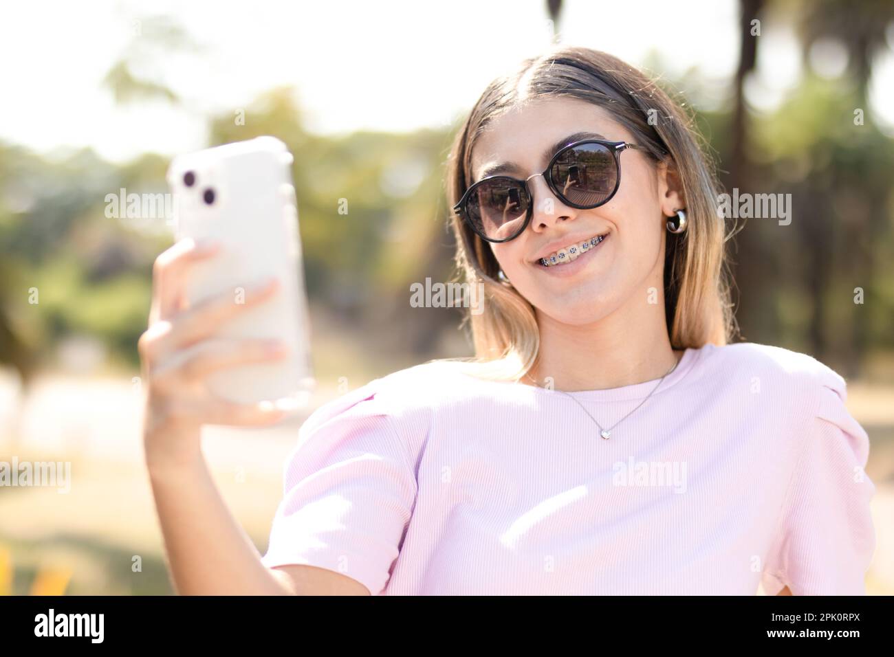 Girl teenager with glasses and braces taking a selfie. Smile for ...