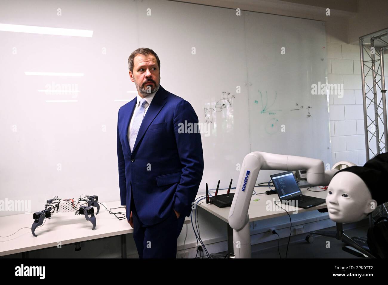 Australian Science Minister Ed Husic takes a look at a roboter during a ...