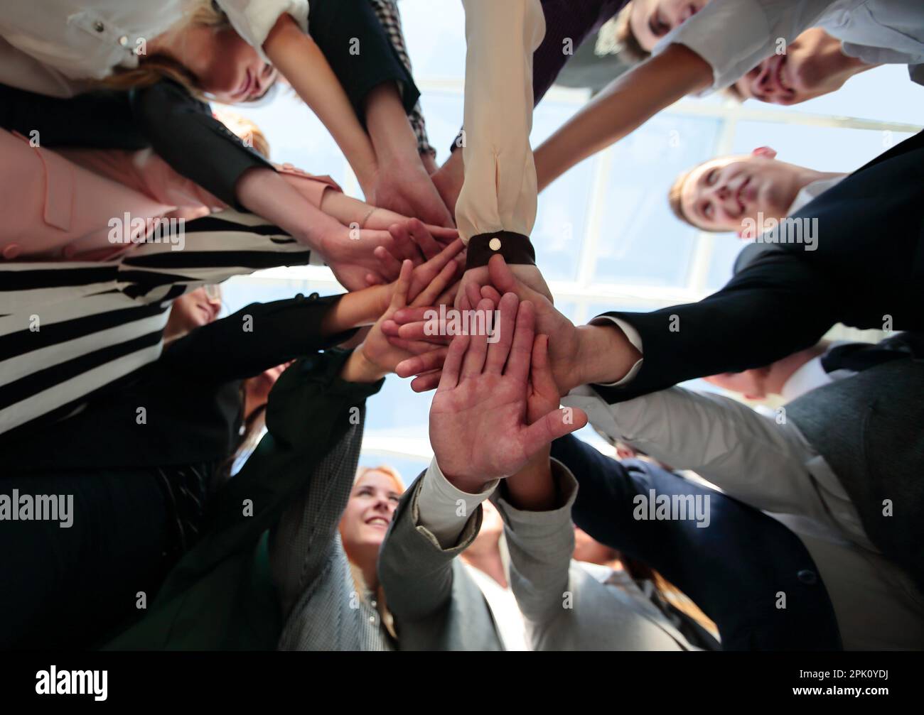 group of diverse young people folding their hands in a circle Stock ...