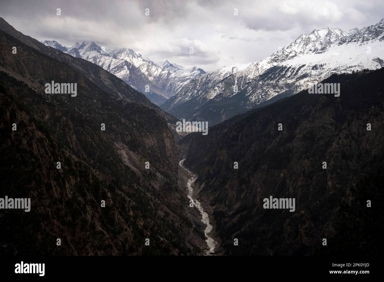 The Sutlej River flows in the valley below the tall snowy peaks in the ...