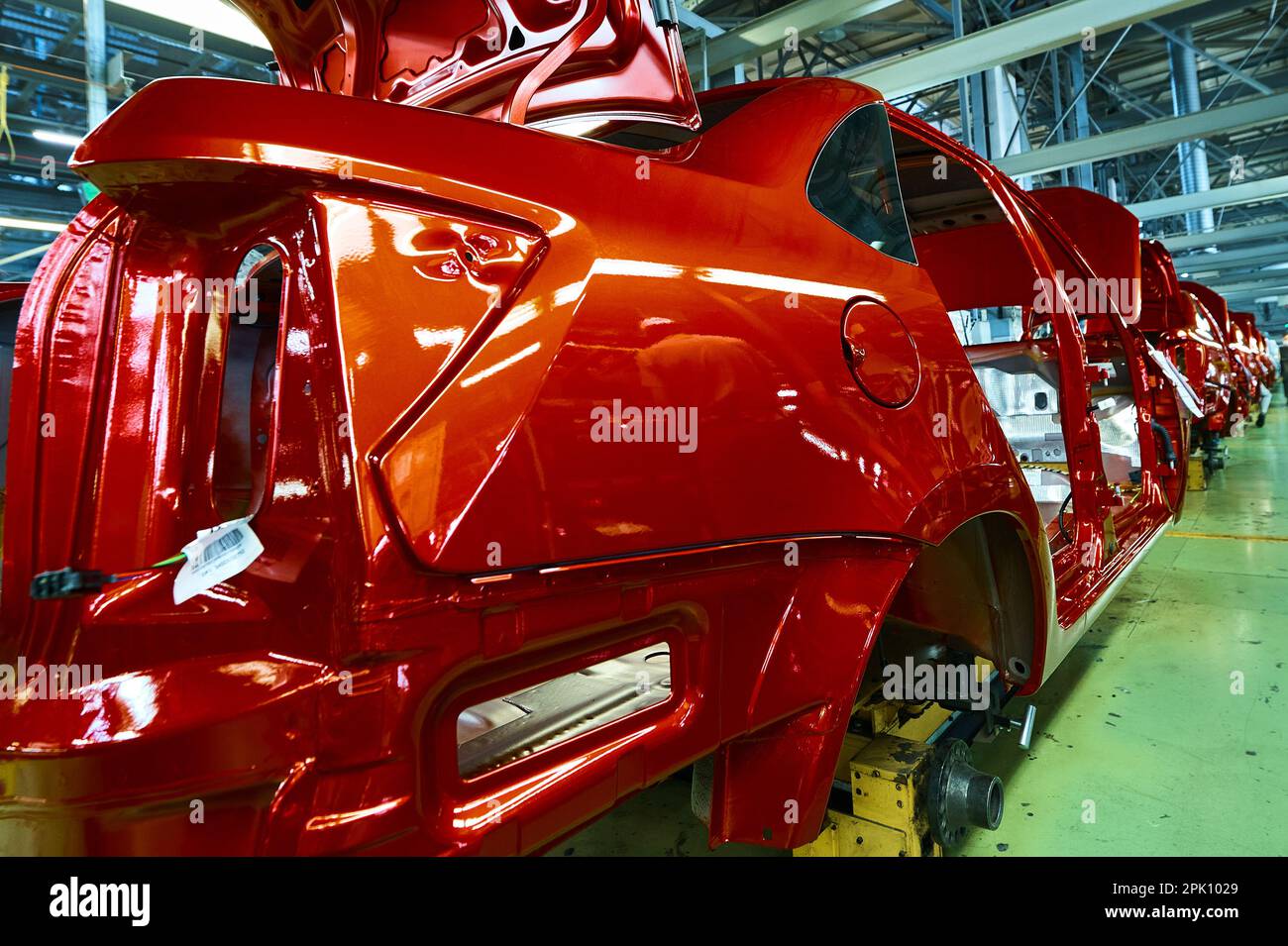 Bright red modern cars bodies in assembling workshop Stock Photo - Alamy