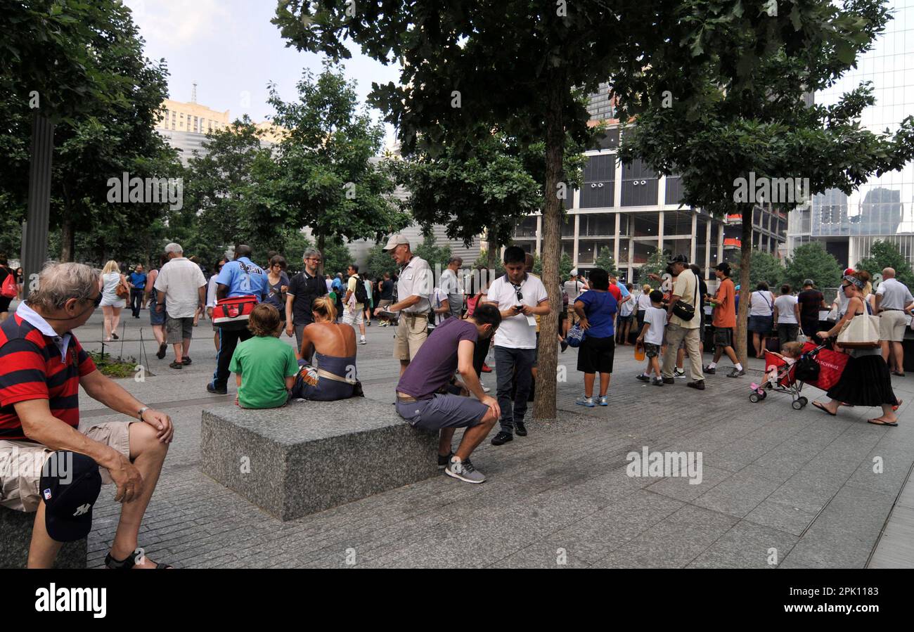 Tourist sitting by the 9/11 memorial in Ground Zero in Lower Manhattan ...