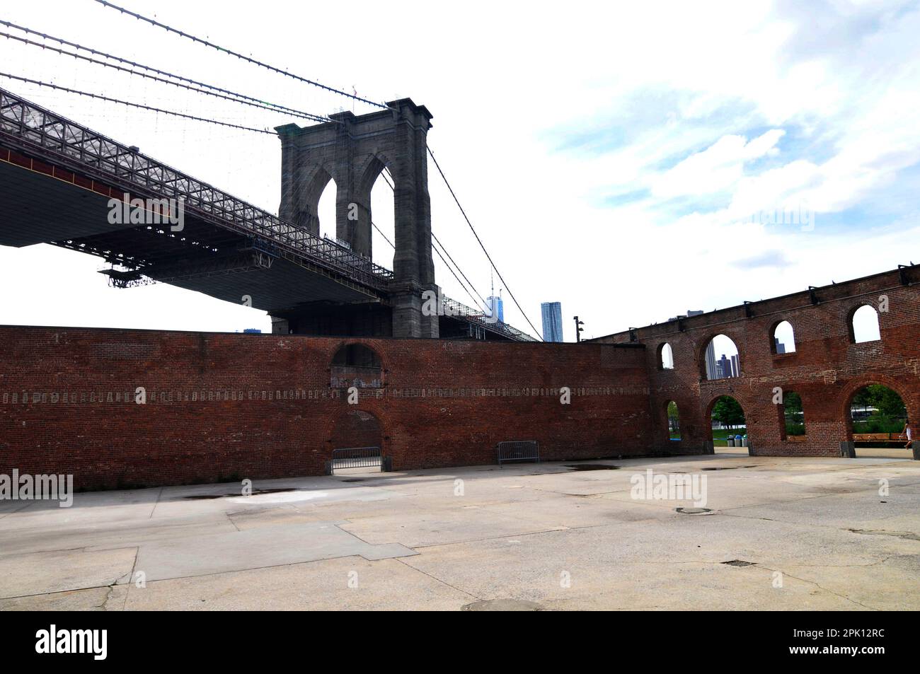 The Brooklyn bridge seen through an old red brick warehouse on the ...