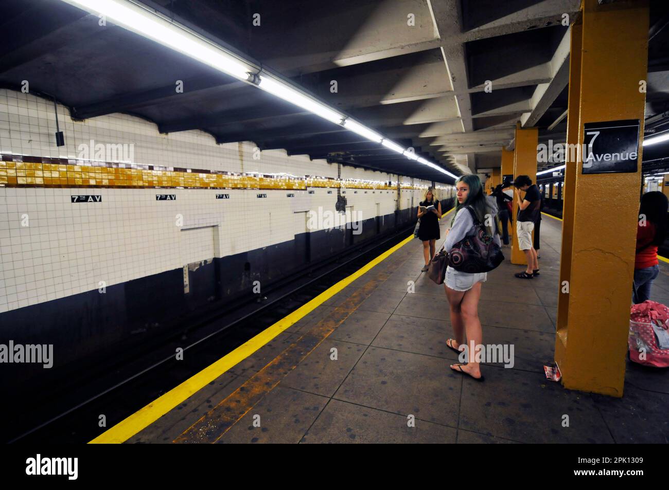 Passengers waiting on the platform of the 7th Avenue station in ...