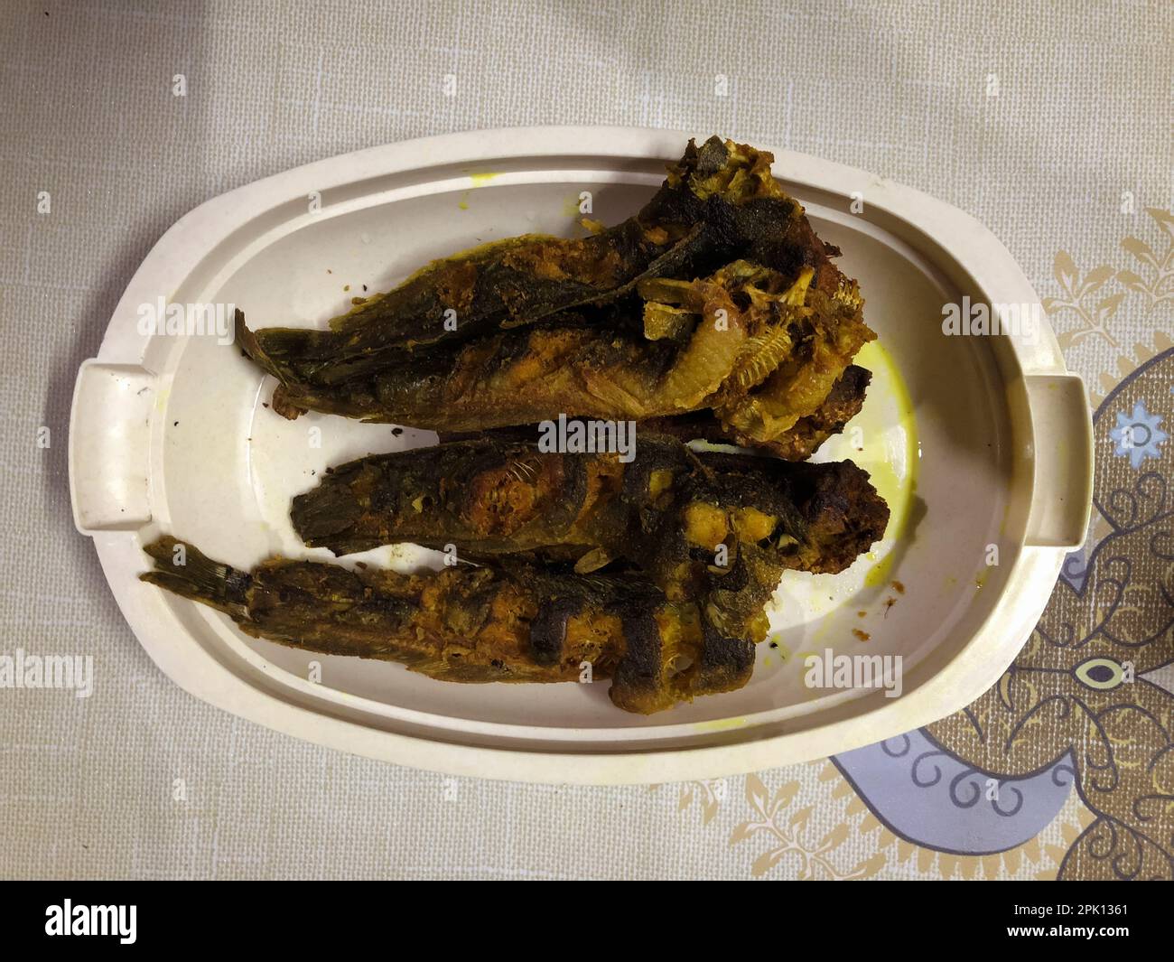 Dried catfish in a white bowl. Selective focus Stock Photo - Alamy