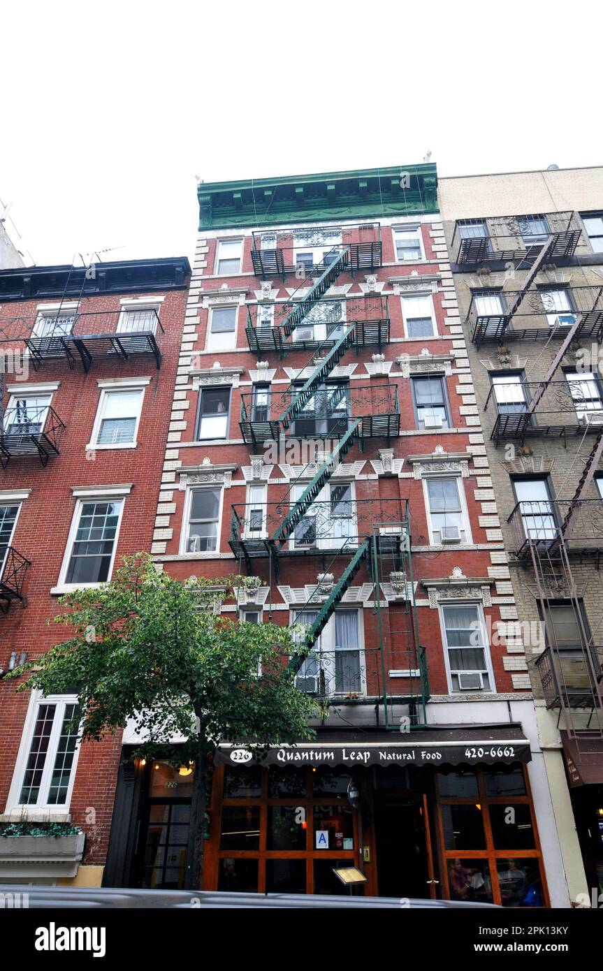 An old apartment building with emergency staircase on W Houston street ...