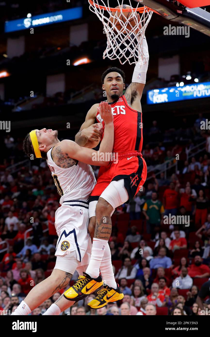 Houston Rockets forward K.J. Martin, right, dunks over Denver Nuggets ...
