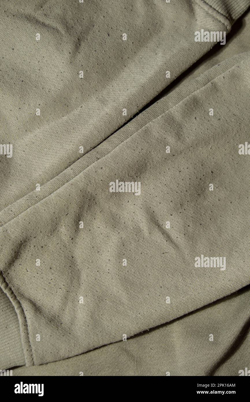 Lints on green sweater. Before cleaning and collected fluff lint ...