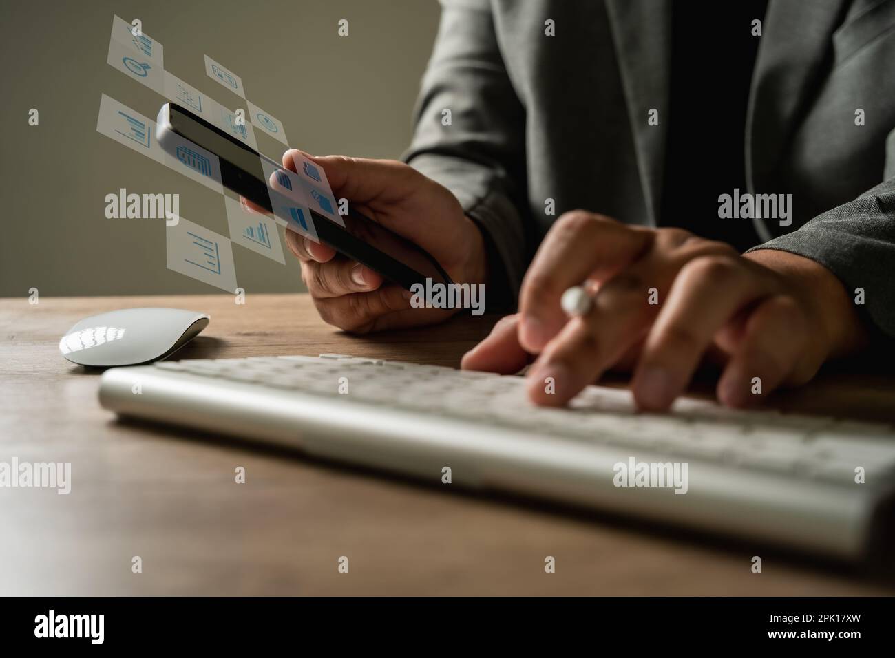Man's hand holding a smartphone with media icons and symbols and ...