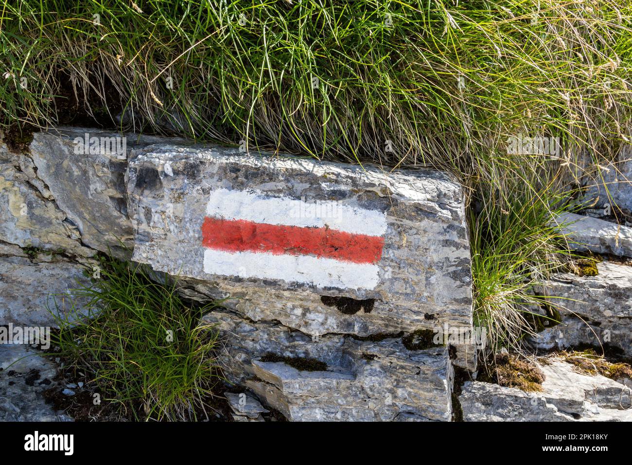 Hiking trails marker on the Swiss Alps by a red and white bars ...