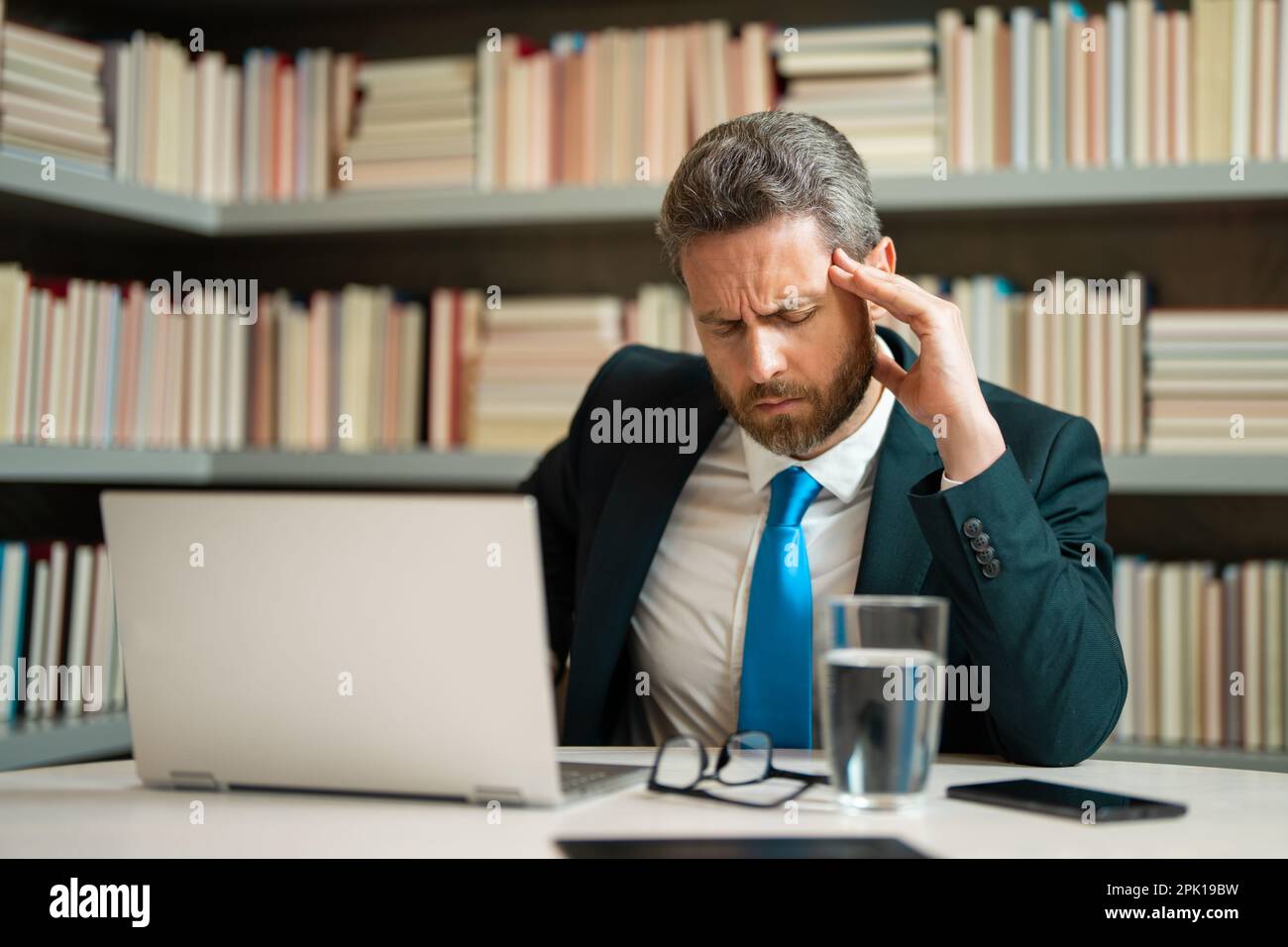 Tired man suffering from headache after computer work, exhausted with ...