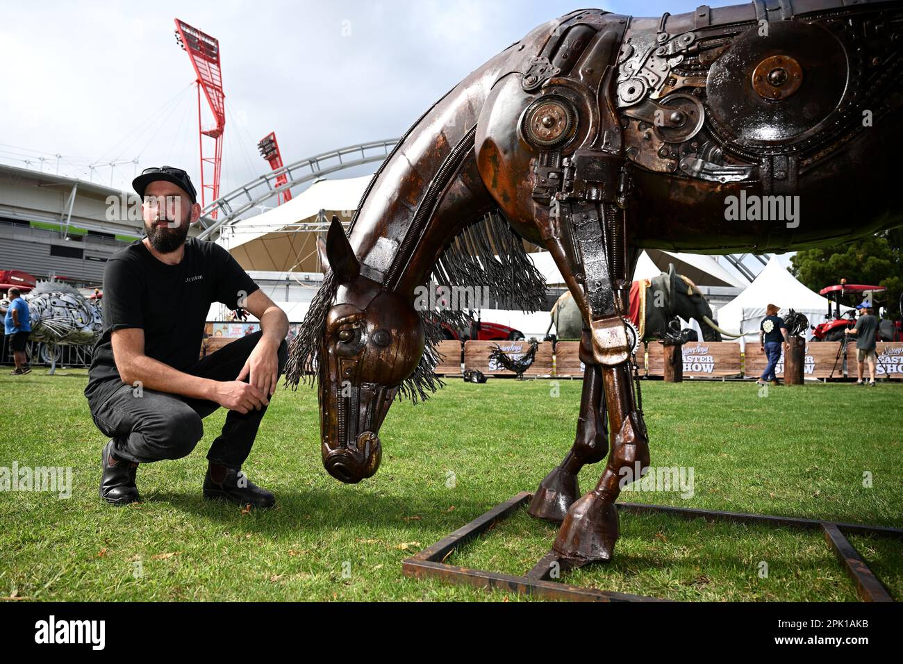 Sculptor Matt Sloane poses for a photo with his artwork during a media ...