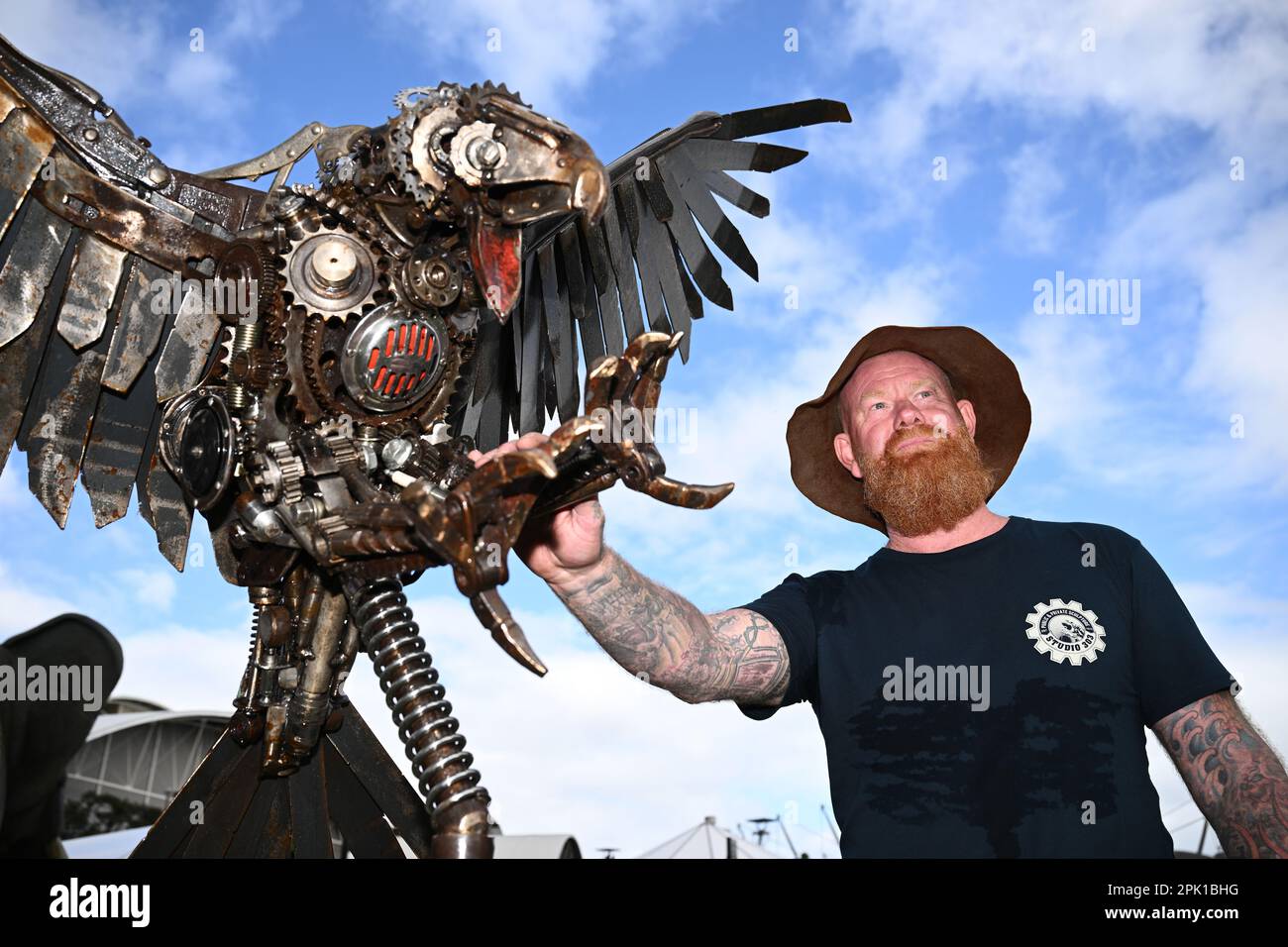 Sculptor Kane Minogue poses for a photograph with his artwork during a ...