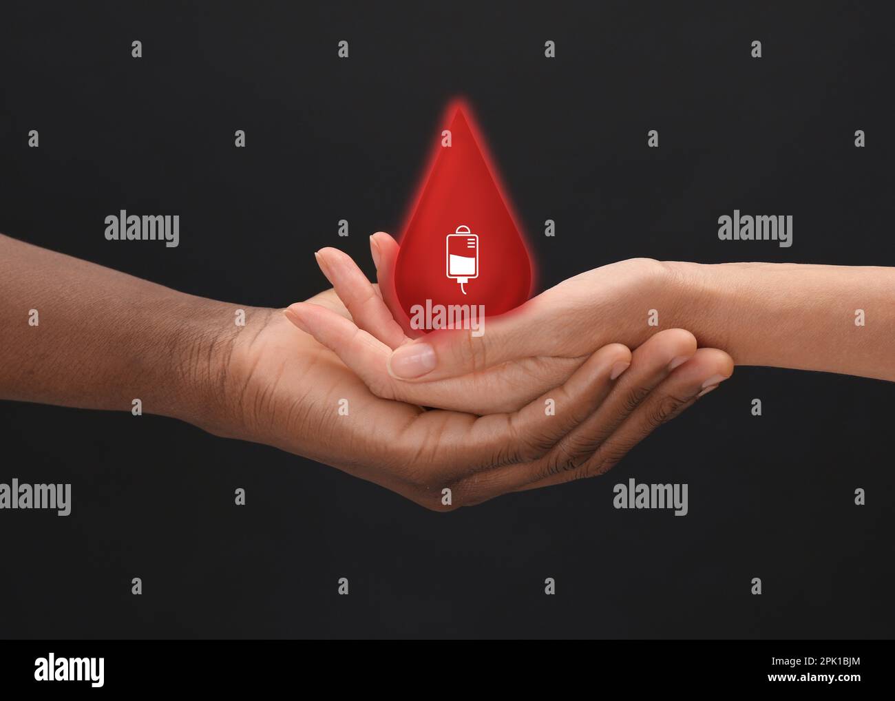 People holding red drop in hands on dark background, closeup. Blood ...