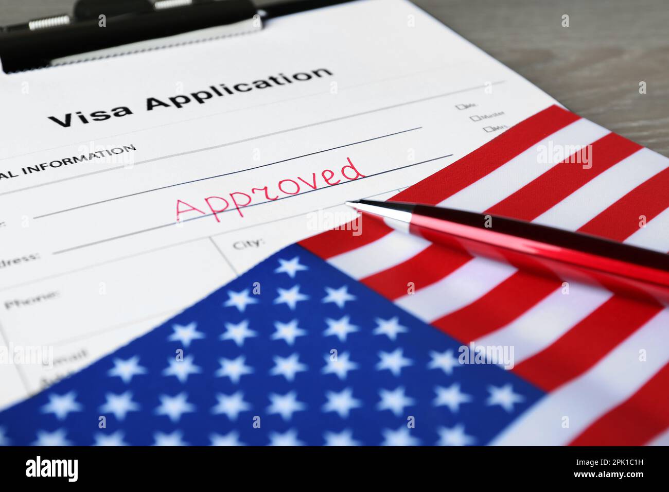 Visa application form with word Approved, American flag and pen on ...