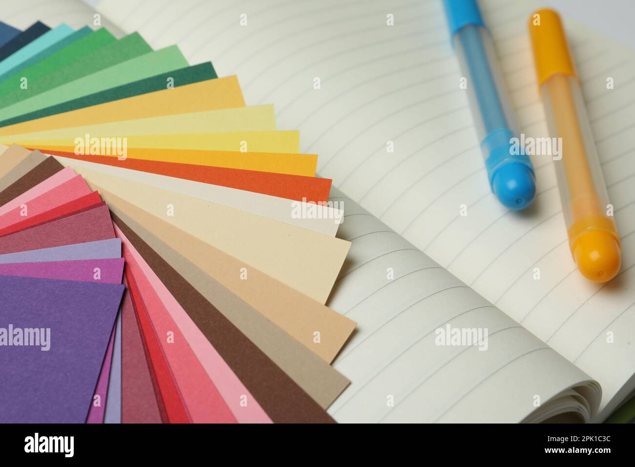 Color palette and pens on notebook, closeup Stock Photo - Alamy