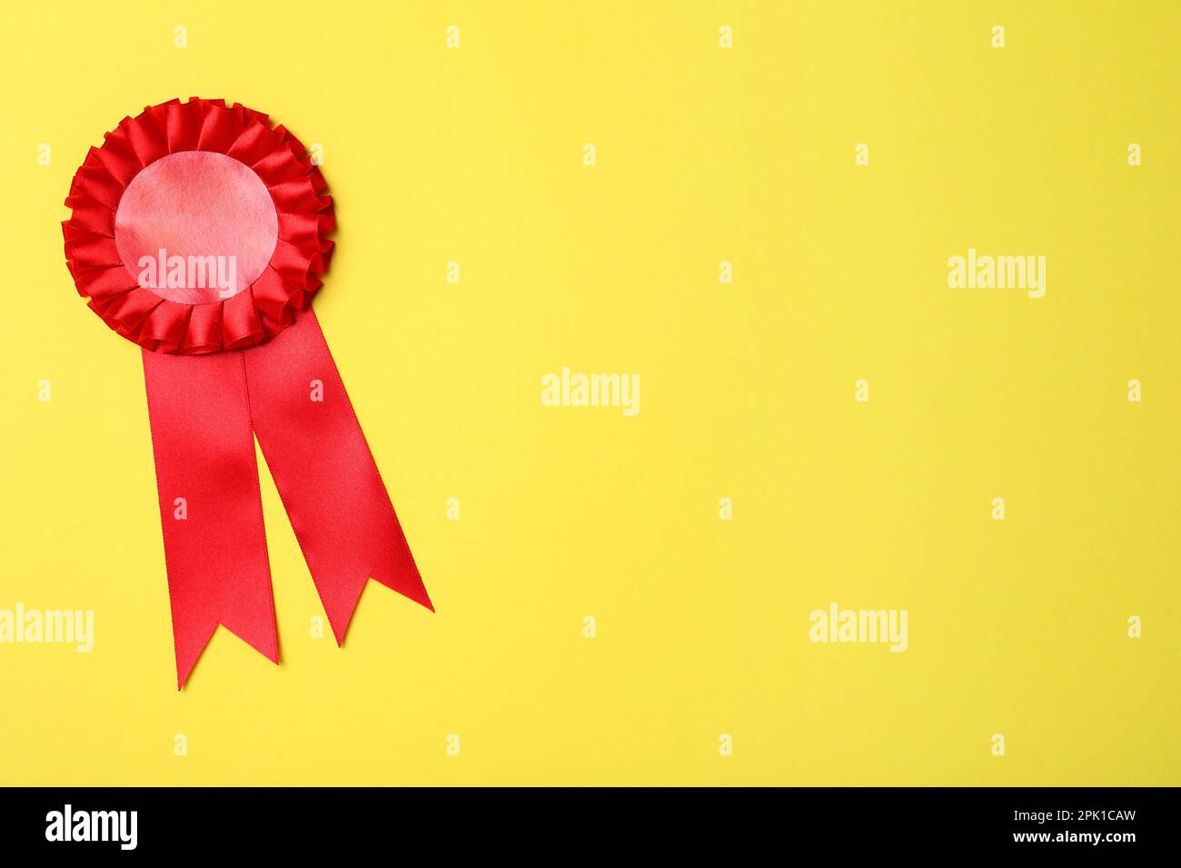 Red award ribbon on yellow background, top view. Space for text Stock ...
