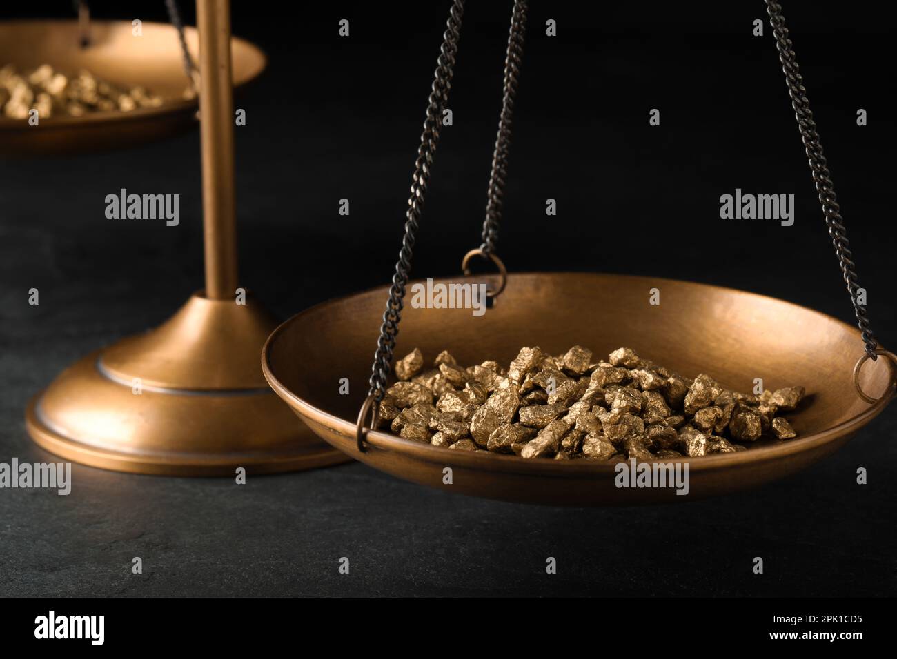 Vintage scales with gold nuggets on dark table, closeup Stock Photo - Alamy