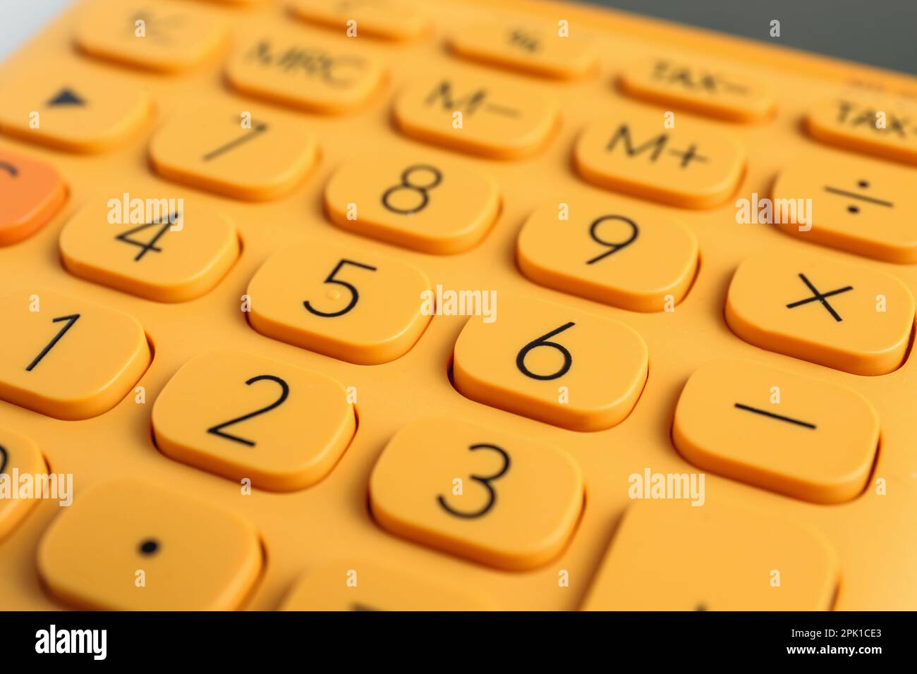 Closeup view of orange calculator as background Stock Photo - Alamy