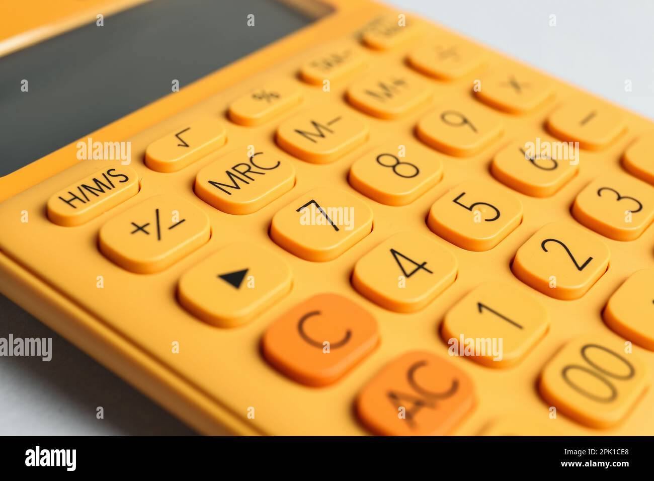 Closeup view of orange calculator on light background Stock Photo - Alamy