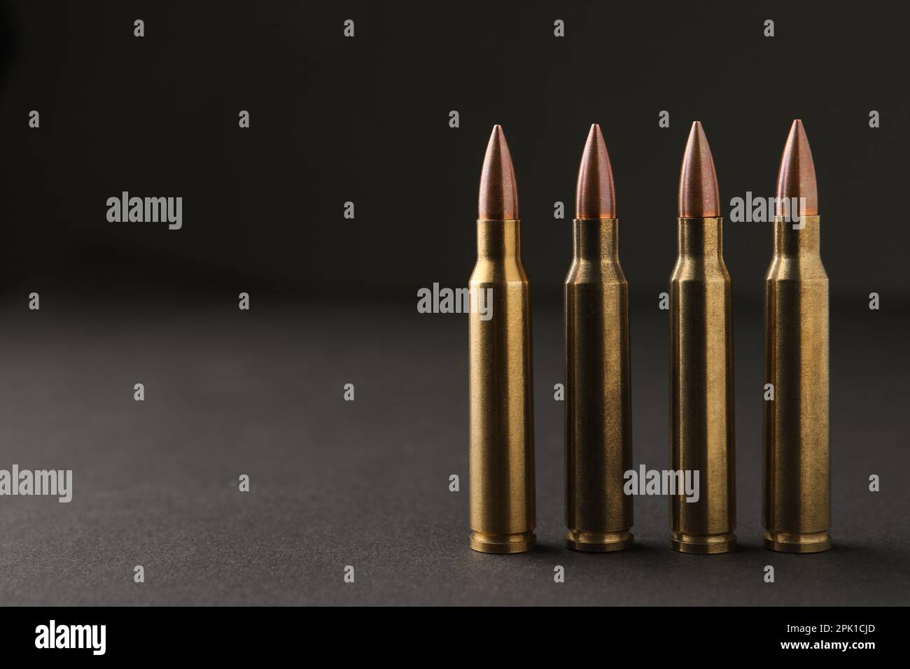 Bullets on black background, closeup. Space for text Stock Photo - Alamy