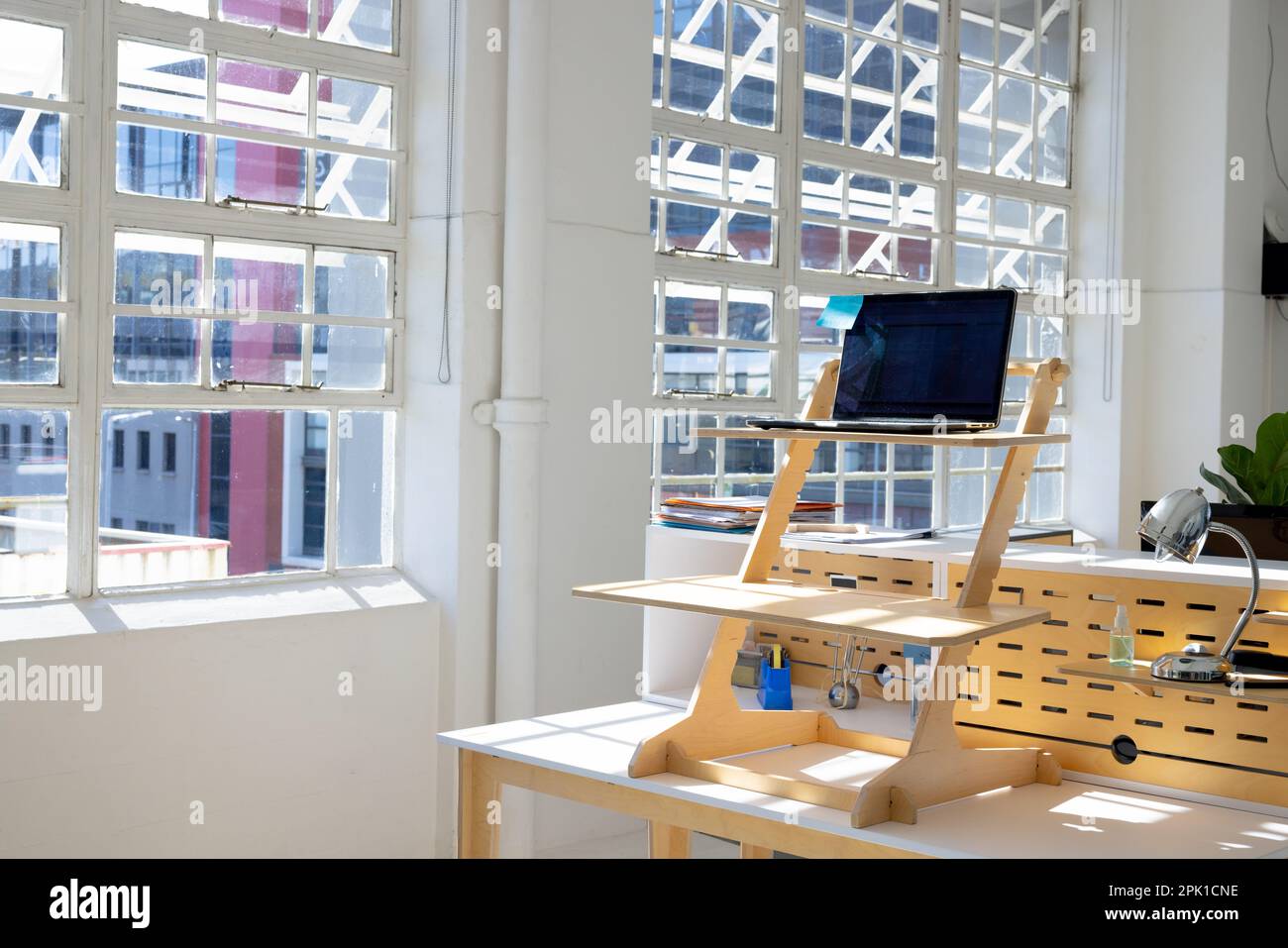 Modern and creative office with windows and technology on wooden parts ...
