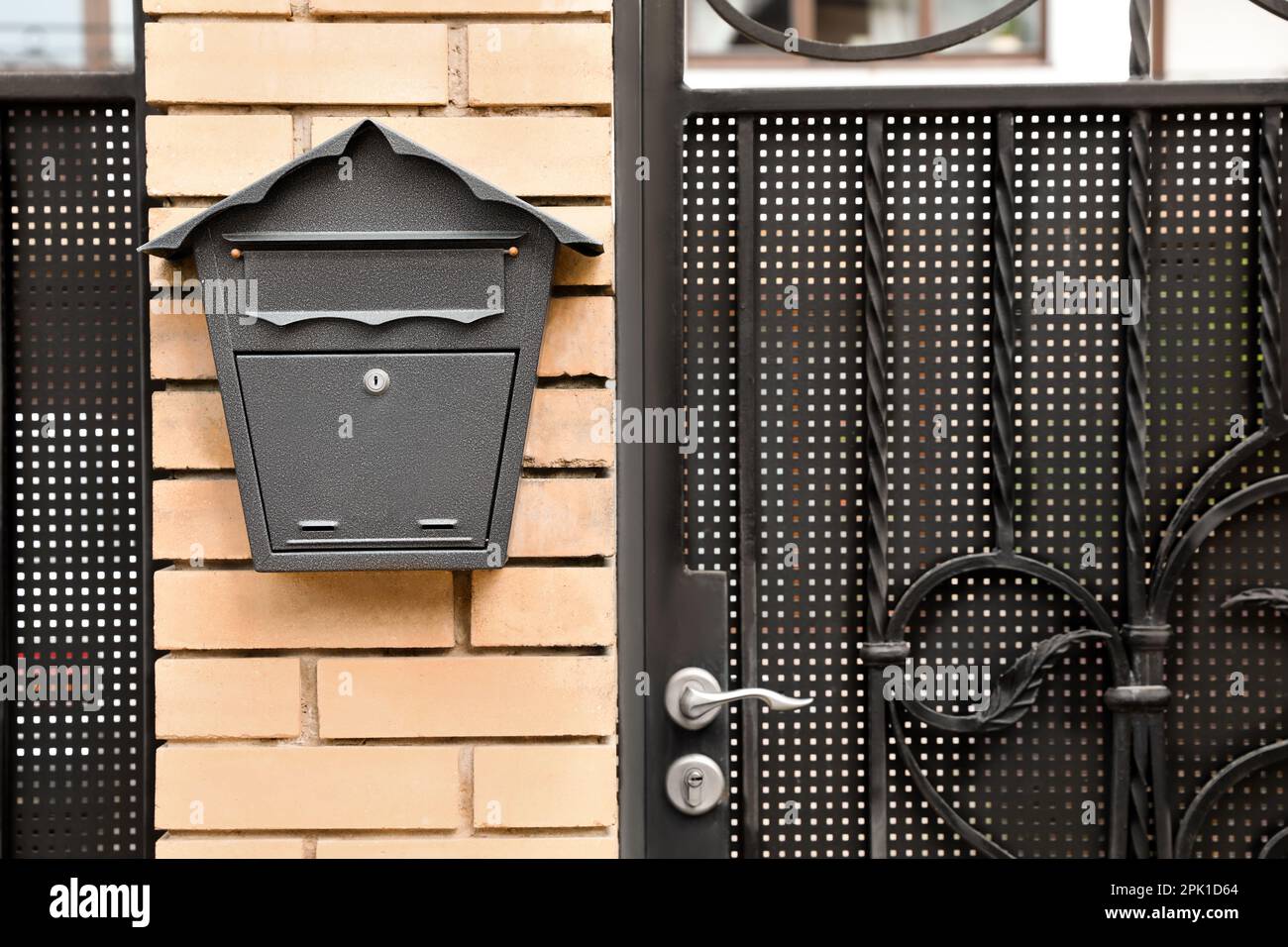 Vintage letter box on beige brick wall near door outdoors Stock Photo ...