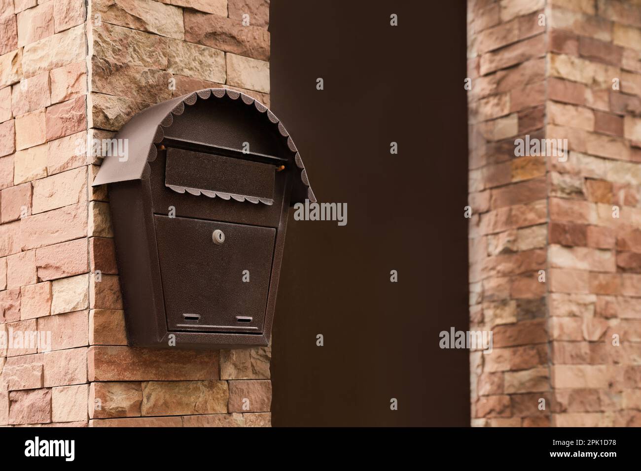 Vintage letter box on brick wall near door outdoors, space for text ...