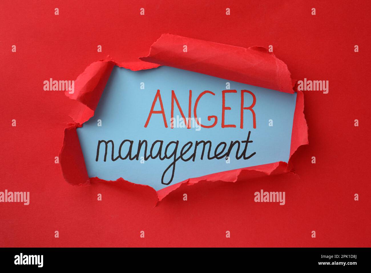Words Anger Management on light blue background, view through hole in ...