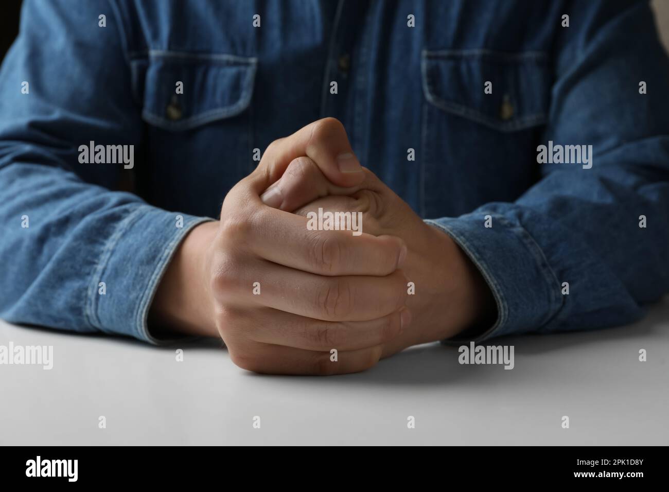 Man clenching hands at table while restraining anger, closeup Stock ...