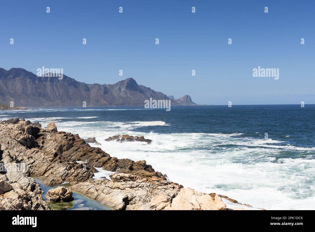 Landscape with mountains, sea, rocks and blue sky, with copy space ...