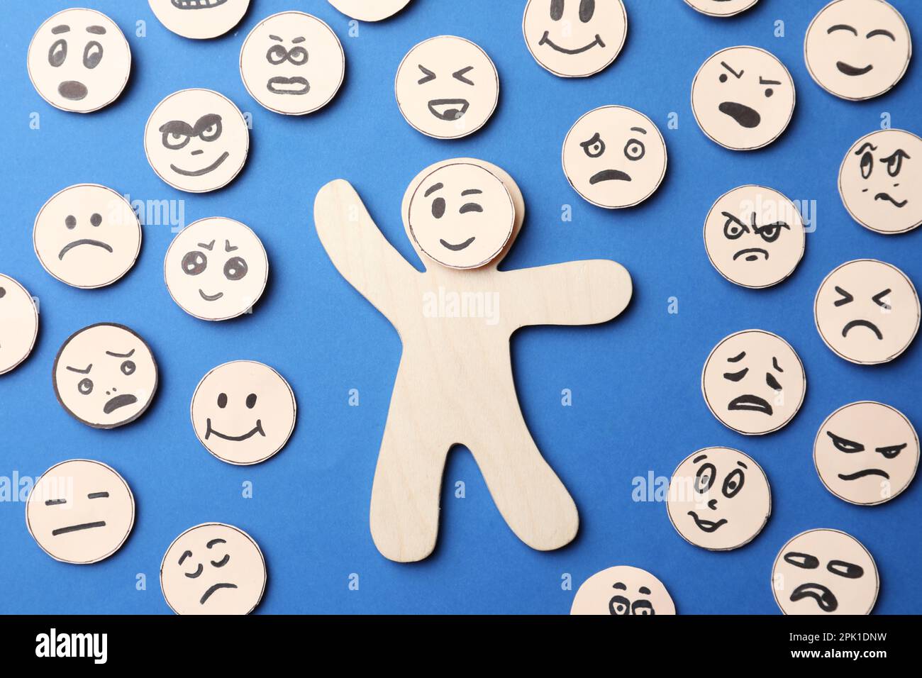 Many faces with different emotions on blue background, flat lay Stock ...