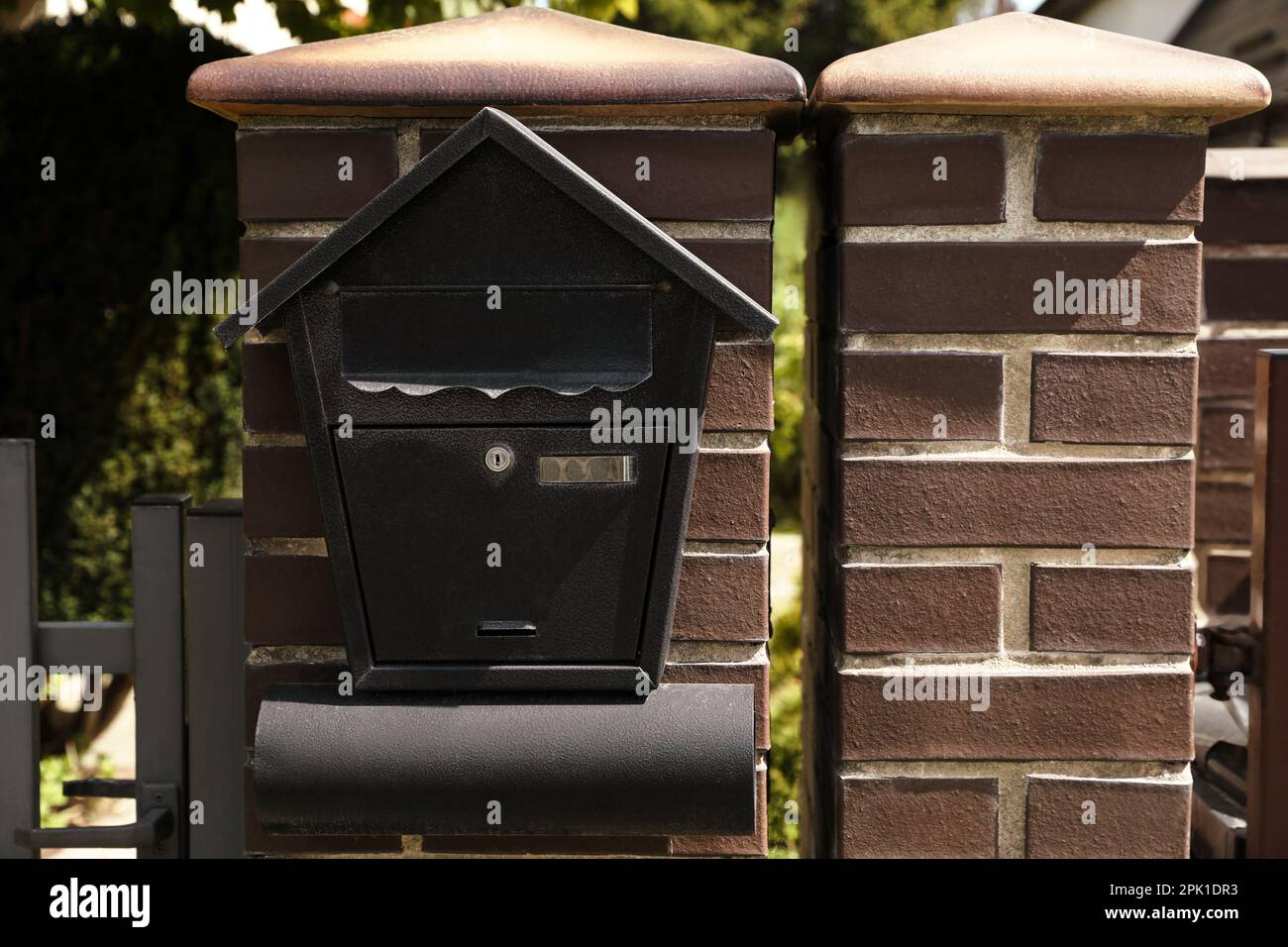 Black metal letter box on brick wall outdoors Stock Photo - Alamy