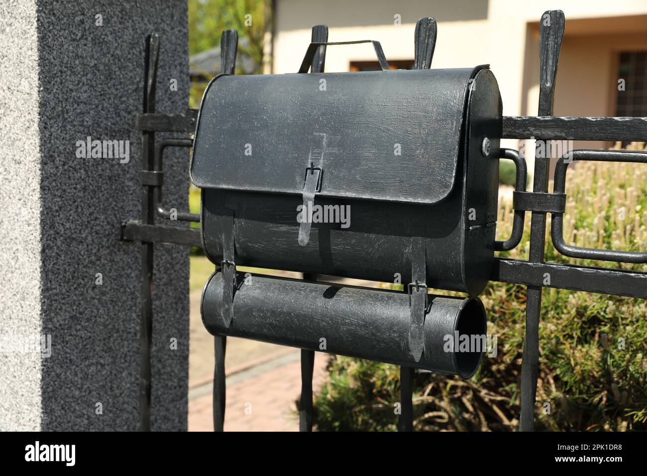 Black metal letter box on fence outdoors Stock Photo - Alamy