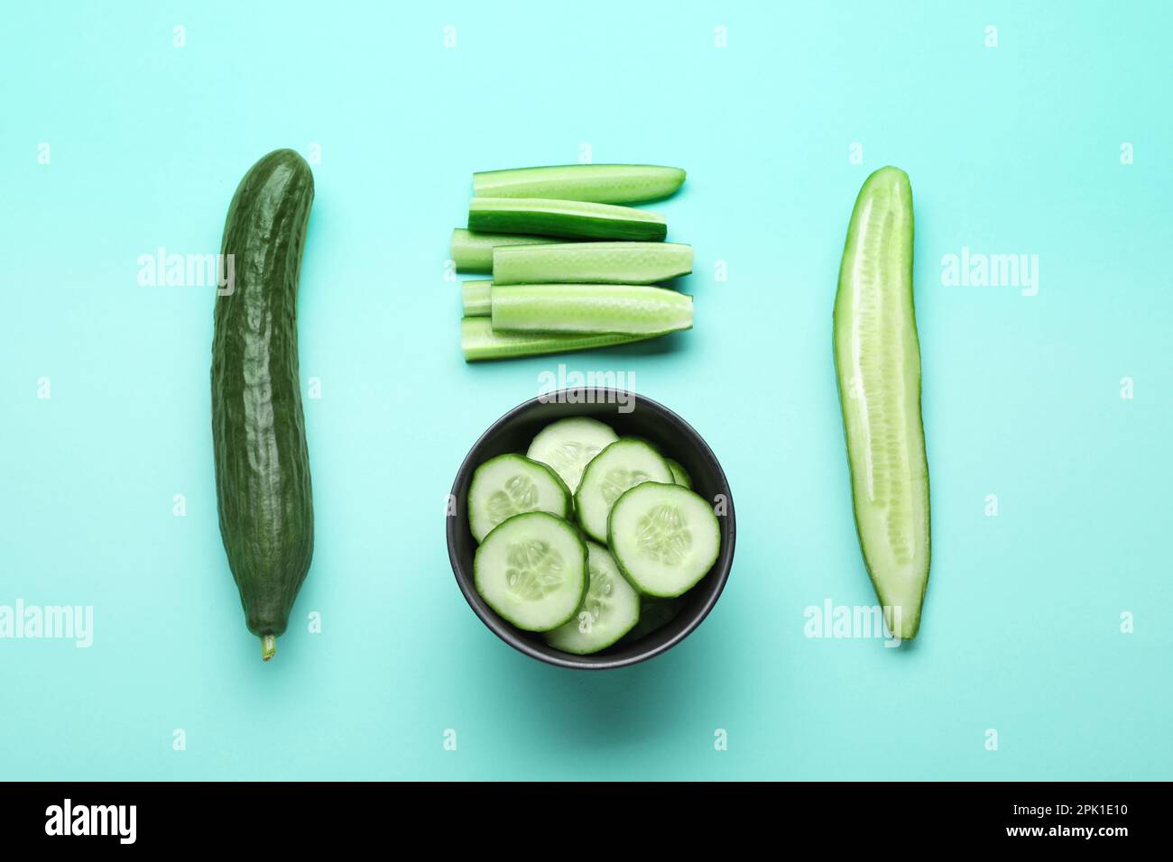 Fresh ripe cucumbers on light blue background, flat lay Stock Photo - Alamy
